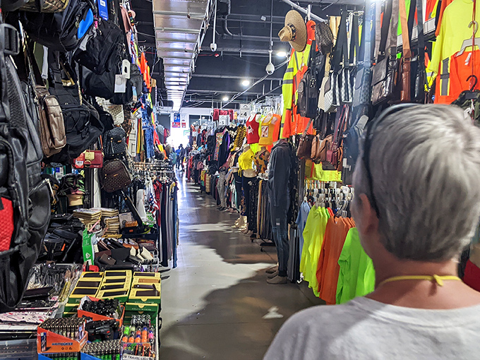 Narrow pathways create a maze of merchandise where shoppers hunt for everything from fashionable handbags to practical household necessities.
