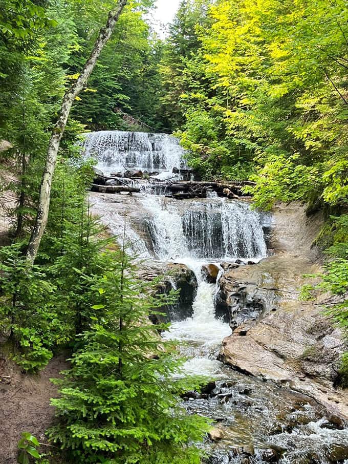 This cascade flows through layers of ancient rock, each level adding its own personality to the performance below.