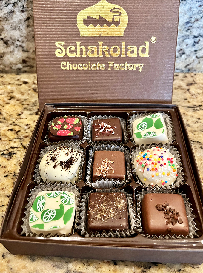 A perfect box of Schakolad's signature bonbons features vibrant designs and unique flavors, from fruity creations to classic chocolate indulgences.