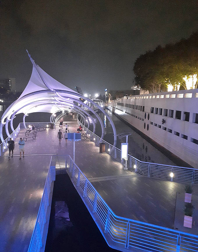 As night falls, the Riverwalk transforms into an electric wonderland, with colorful lights dancing across the water like nature's own light show.