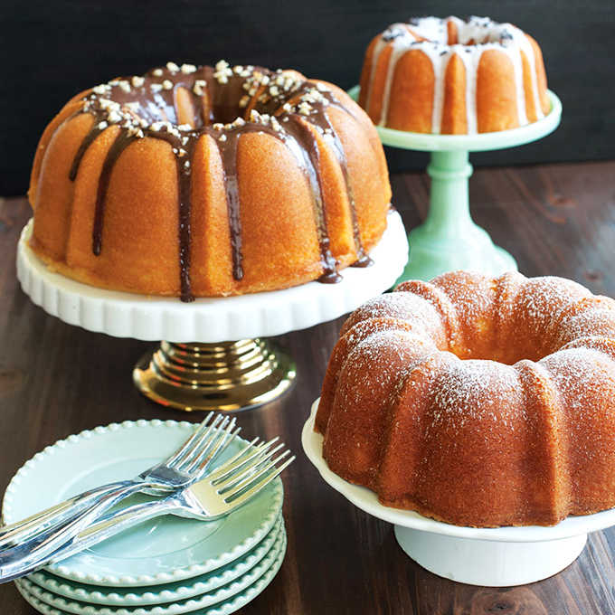 Golden perfection in ring form. These classic Bundt cakes showcase the pan's genius, creating that irresistible balance of tender crumb and delicate crust.