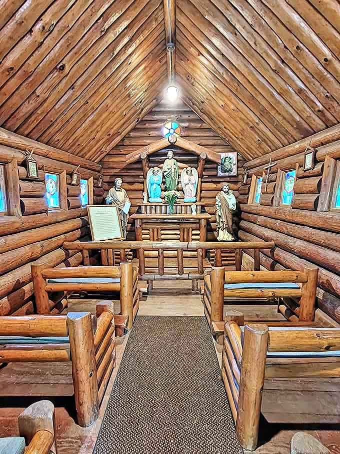 The log chapel offers a moment of quiet reflection, its rustic beams and simple benches creating a sanctuary within a sanctuary.