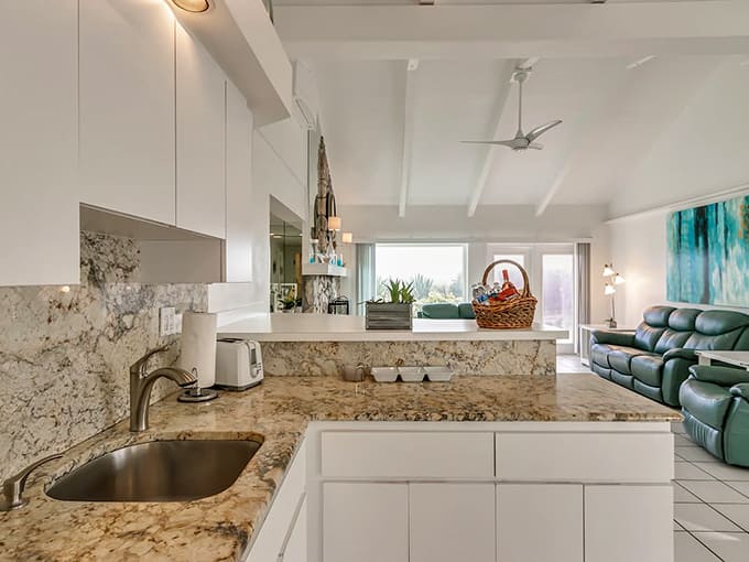 This kitchen's granite countertops and bright white cabinets make meal prep feel less like a chore and more like vacation activity.