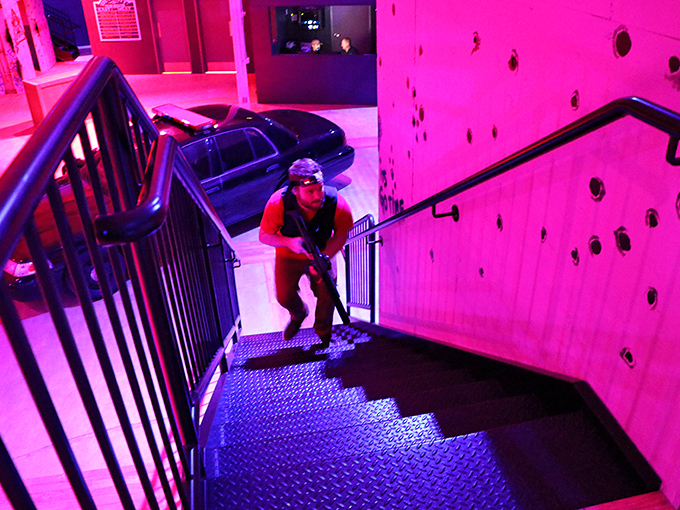 Navigating the neon-lit stairwell requires both stealth and strategy. The dramatic lighting transforms ordinary architecture into a tactical challenge worthy of your favorite action movie.