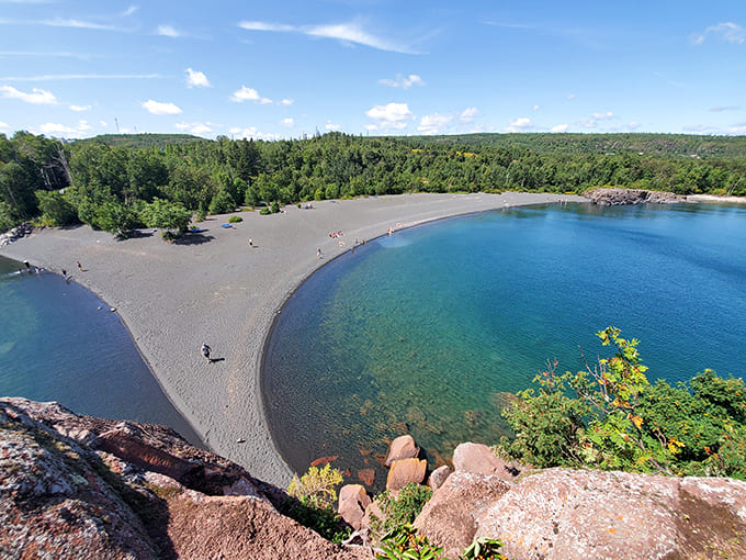 From above, the contrast between dark sand and blue water creates a natural work of art that changes with every shift in light and weather.