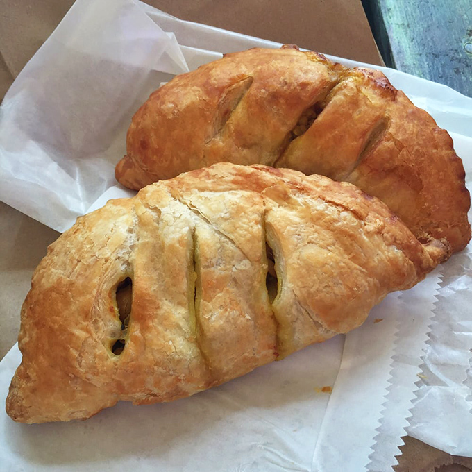 Golden-brown samosas with perfectly crimped edges promise a flavor explosion that might just make you forget your table manners.