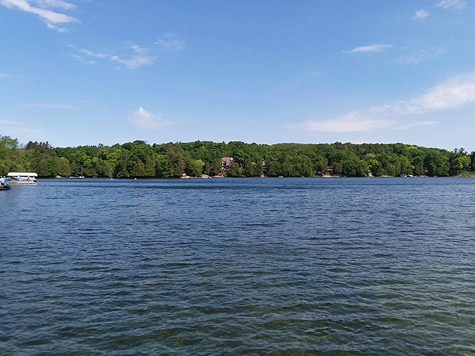 The shoreline stretches invitingly along Crystal Lake, where the forest meets water so clear it seems almost invisible.