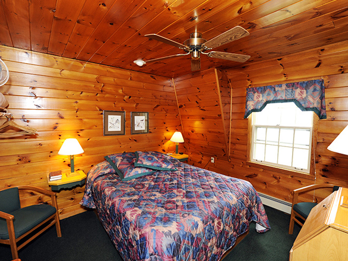 Warm pine walls embrace visitors in this rustic bedroom, creating the perfect cocoon for dreams filled with Lake Superior adventures.