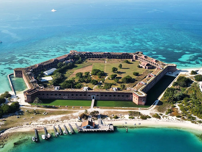 Fort Jefferson stands like a brick sentinel amid turquoise waters, looking like someone dropped ancient Rome into Caribbean paradise.