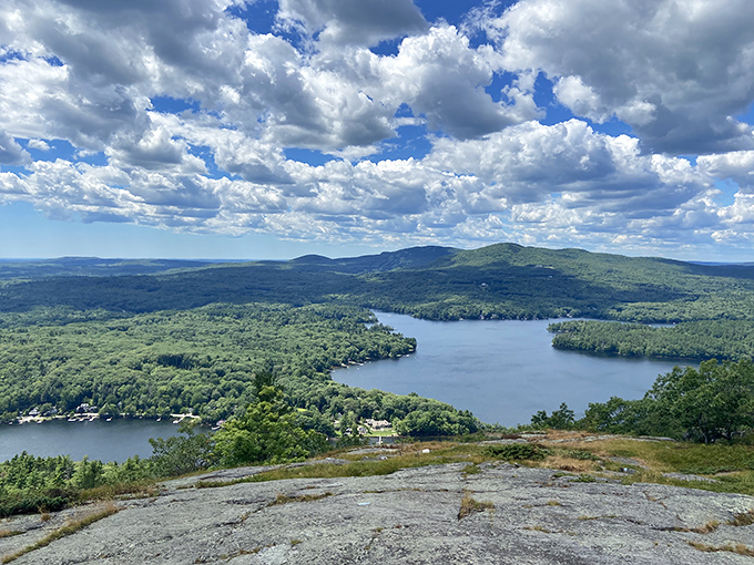 The panoramic vista stretches to infinity, where rolling hills meet the endless blue of Penobscot Bay in nature's perfect embrace.