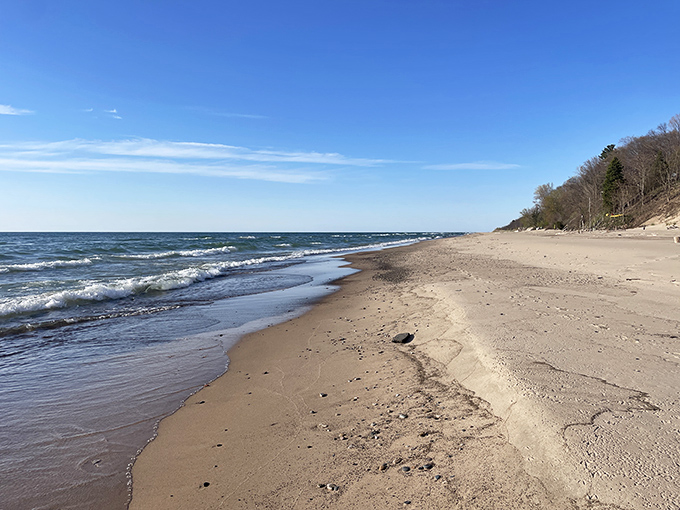 Waves gently kiss the sandy shore, each retreat potentially revealing colorful glass gems to eagle-eyed beachcombers.