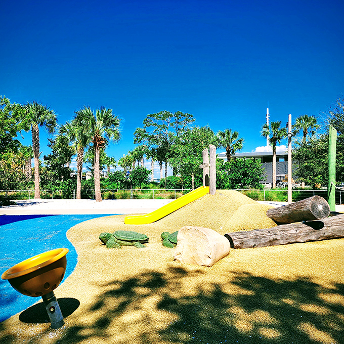 Yellow slides emerge from sandy-colored surfaces like sunshine breaking through ocean depths &ndash; a perfect Florida playground moment captured.