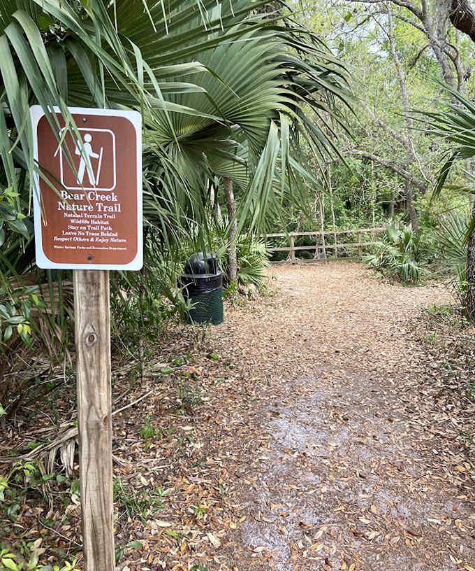The Bear Creek Nature Trail sign welcomes visitors with rustic charm, promising adventures that feel worlds away from suburban life.