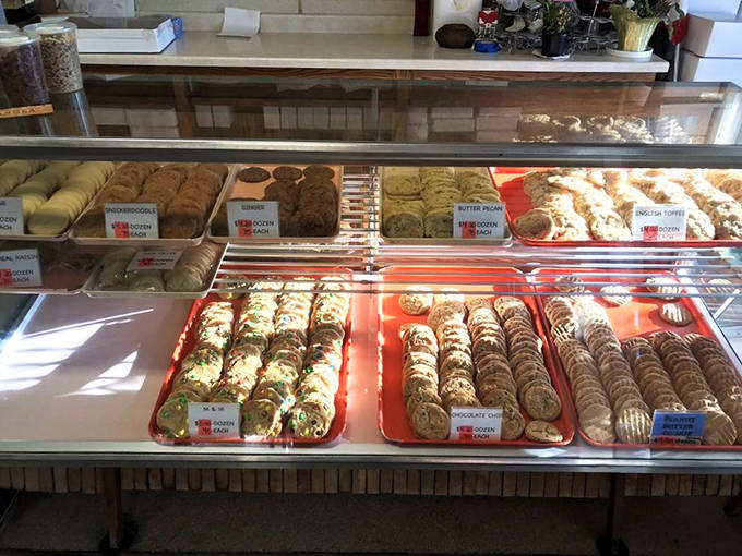 The display case isn't just holding pastries &ndash; it's showcasing edible art with labels that promise flavor adventures for every palate.