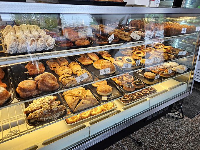 Donut dreams come true at A Baker's Wife! Their display case showcases perfectly crafted treats from chocolate-dipped delights to powdered sugar classics.