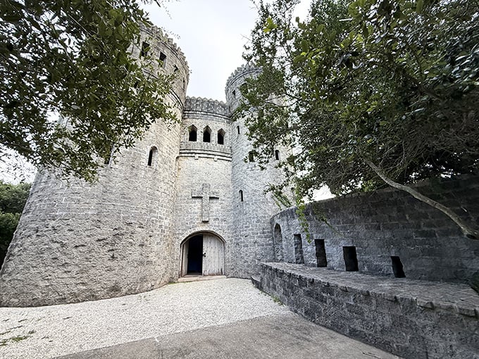 Castle Otttis rises from the Florida landscape like a medieval dream, its stone towers and cross emblem creating an unexpected sight among the palm trees.