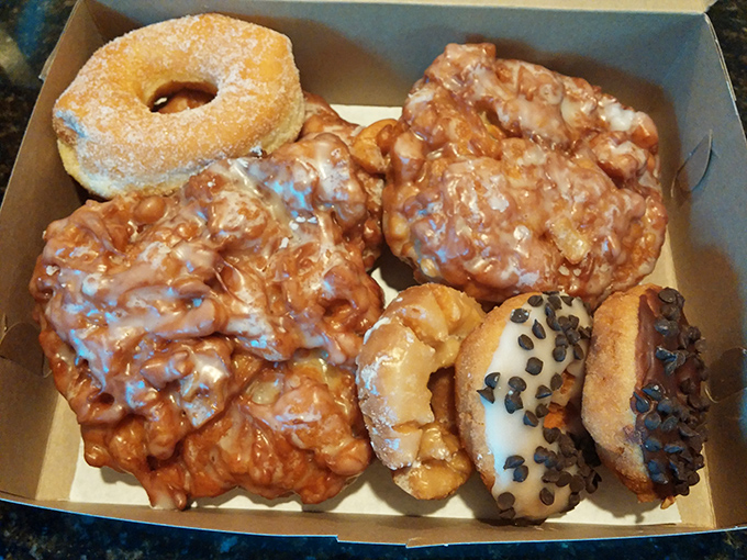 Donut perfection! These golden-fried apple fritters and chocolate-dipped beauties showcase Donutville's mastery of donut classics.