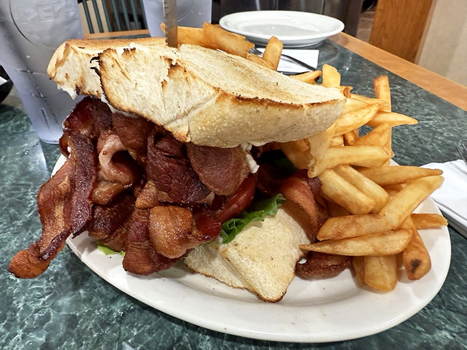 That's not just a BLT – it's a monument to bacon excess, featuring a full pound of crispy goodness that makes first-timers gasp in disbelief.