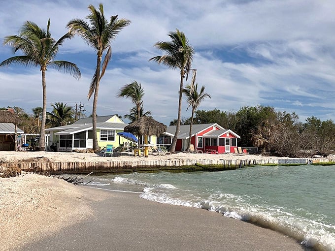 Colorful beachfront cottages stand as cheerful sentinels, their weathered charm perfectly complementing the natural landscape.