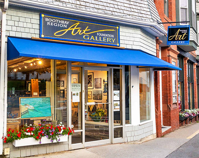 The Boothbay Region Art Foundation showcases local talent beneath a vibrant blue awning, where Maine's beauty gets translated to canvas.