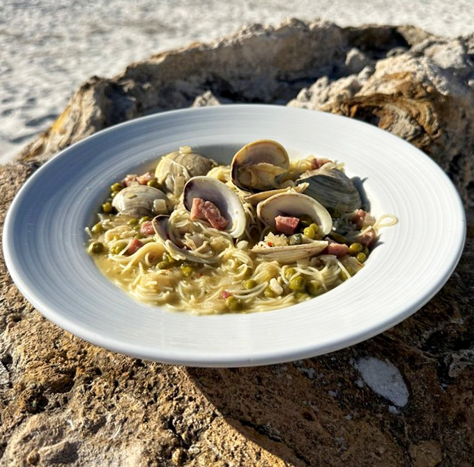 This isn't just pasta &ndash; it's a seafood symphony where delicate clams harmonize with perfectly cooked capellini in a broth you'll want to drink.