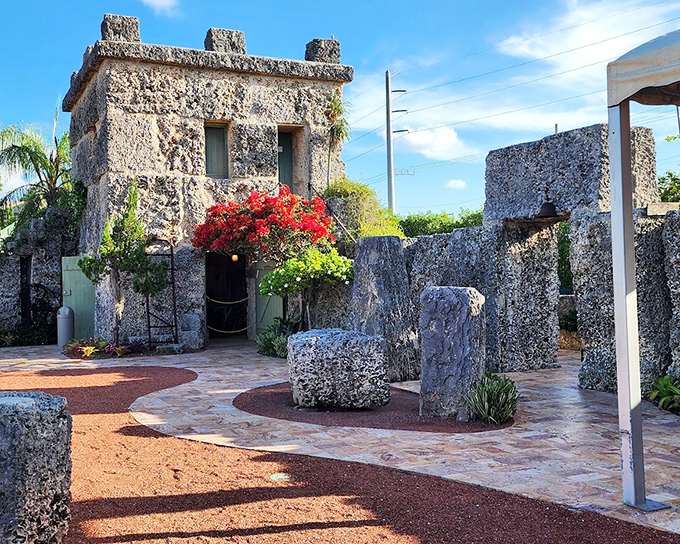 The castle's stone dwelling stands as a testament to simplicity, adorned with vibrant bougainvillea that softens the rugged coral.