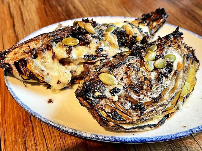 Charred arrowhead cabbage transforms the humble vegetable into a star attraction, proving that sometimes the simplest ingredients make the most memorable dishes.