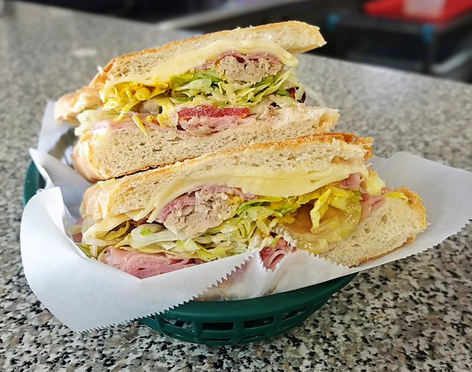 Behold the star attraction – layers of ham, roasted pork, Swiss cheese, pickles, and mustard pressed to crispy perfection.
