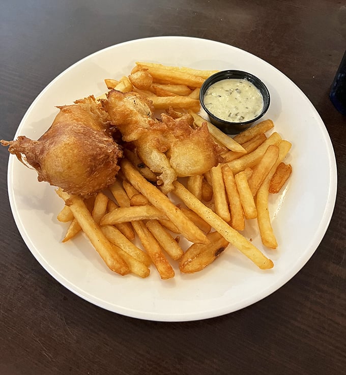 Fish & Chips: Golden-battered perfection meets seaside tradition&mdash;crispy on the outside, flaky within, and that sauce? Chef's kiss!
