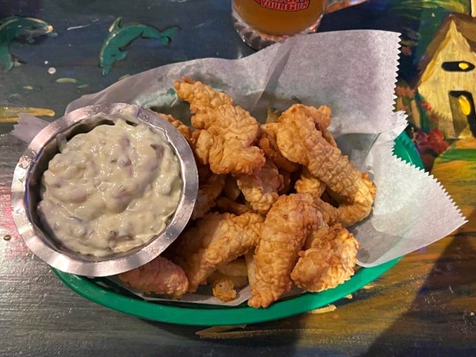 Golden-fried perfection meets creamy tartar sauce &ndash; these crispy morsels aren't just fish and chips, they're an edible love letter to the ocean.