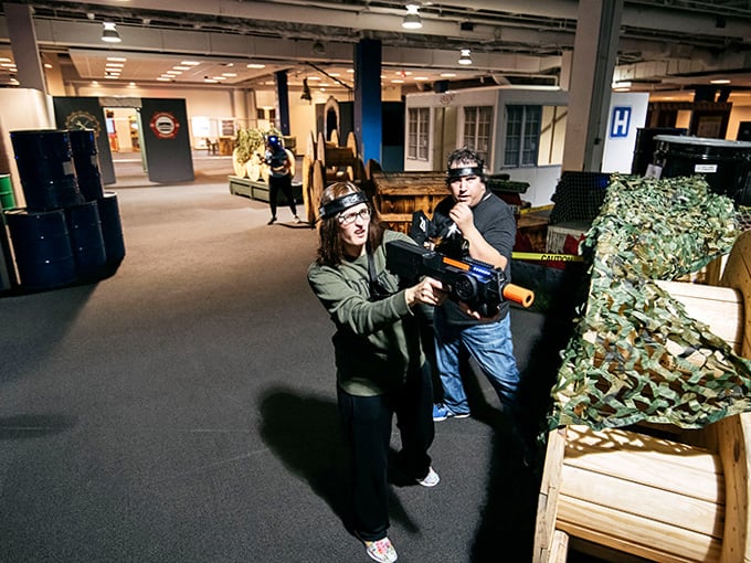 Players take cover behind strategic barriers, their faces alight with the kind of joy usually reserved for finding money in old coat pockets.