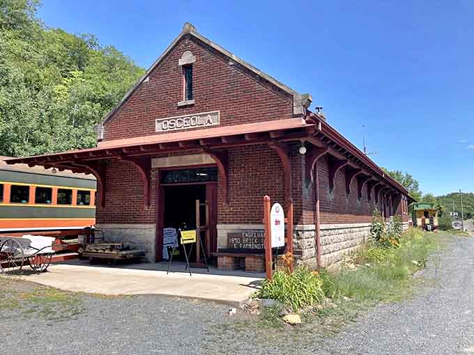 The brick Osceola Depot stands as a testament to railroad glory days, its 1916 architecture lovingly preserved as the gateway to scenic rail adventures.