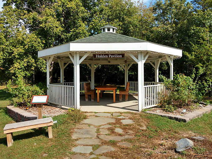 The elegant Holden Pavilion creates a serene gathering space, its white columns framing nature's artwork like a living gallery.