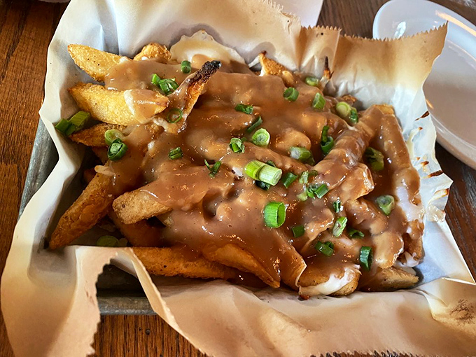 These aren't your average fries &ndash; Atwater's poutine arrives smothered in rich gravy and cheese curds, topped with green onions for a pop of freshness.
