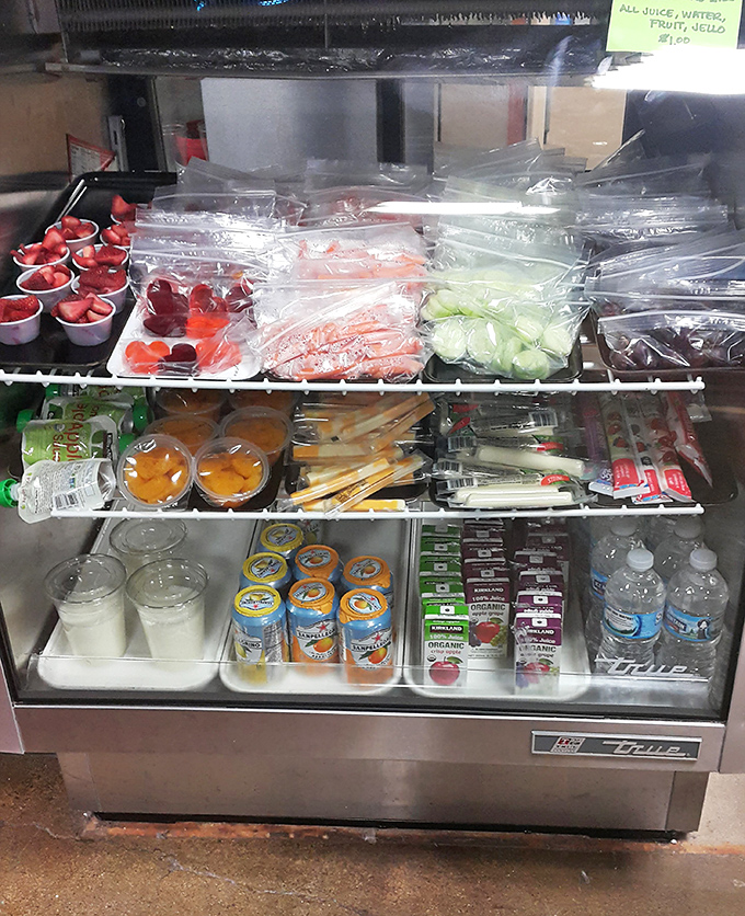 Fresh fruits, veggies, and healthy snacks line the cooler – because even superheroes need proper fuel between slide sessions.