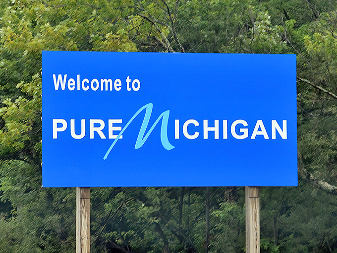 New Buffalo's welcome sign promises the perfect trifecta of Michigan pleasures – shops for browsing, sand for lounging, and smiles for everyone.