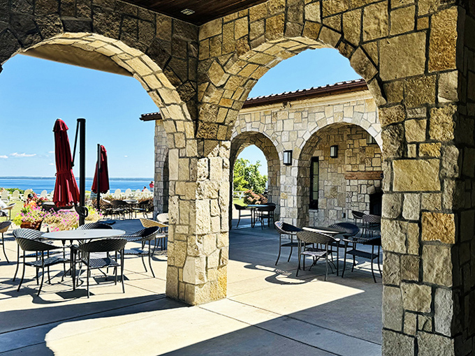 Stone arches frame picturesque views like living postcards, creating natural portals between the rustic elegance of the winery and the breathtaking Michigan landscape beyond.