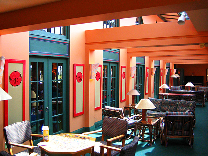 Sunlight streams through windows in the lounge area, where comfortable chairs invite hours of conversation or quiet contemplation of lake views.