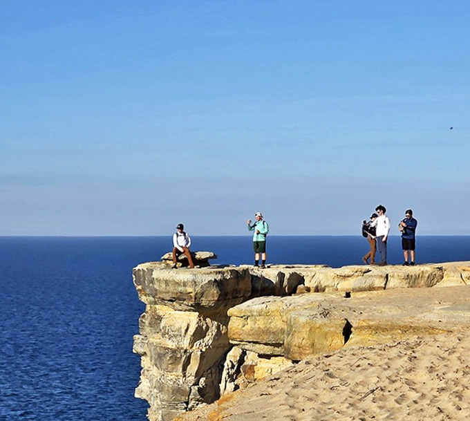 Adventurers perched on sandstone cliffs, contemplating the vastness of Lake Superior &ndash; Michigan's version of living on the edge.