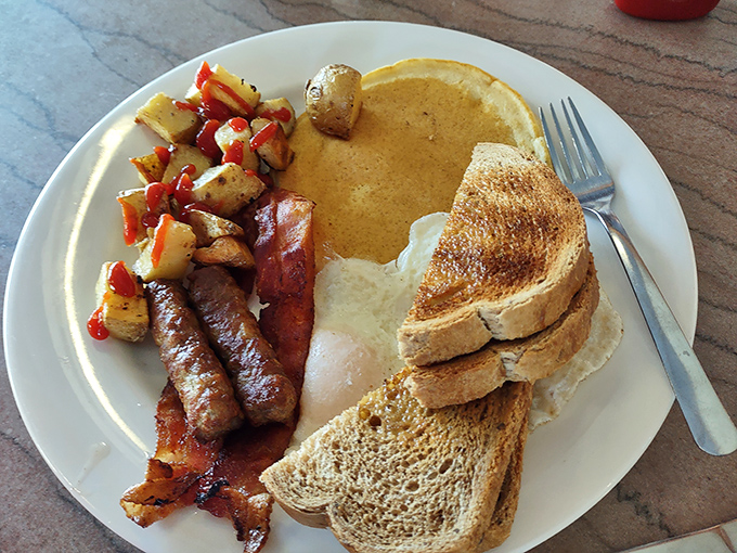 Breakfast perfection on a plate &ndash; golden pancakes, eggs just right, and those home fries that somehow taste better in a diner.