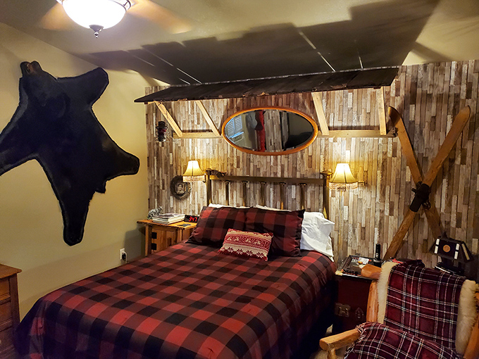 Buffalo plaid bedding and rustic wood walls transform this bedroom into a northwoods retreat that would make Paul Bunyan jealous.