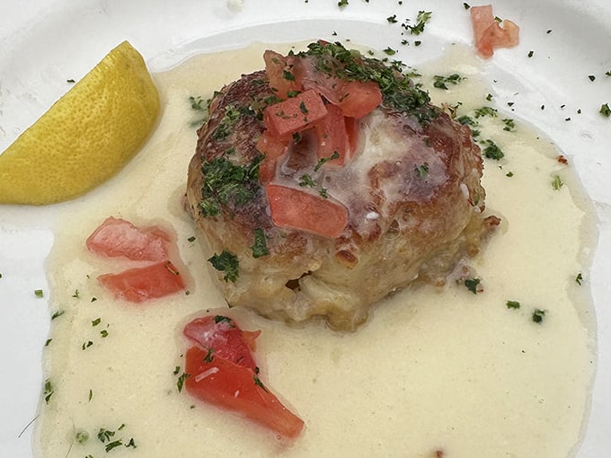 This isn't just any crab cake &ndash; it's a golden-crusted island of joy swimming in citrus beurre blanc. Fork, meet happiness.