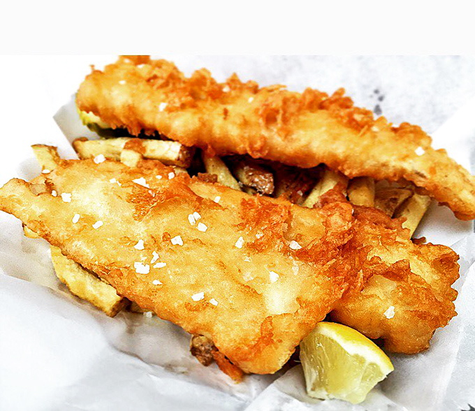 Golden-battered fish fillets rest atop a bed of hand-cut fries &ndash; a simple combination elevated to art form through perfect execution.