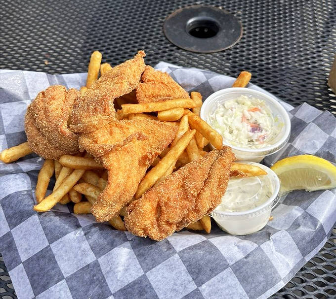 Golden-battered fish rests atop a bed of perfectly crisp fries, a symphony of textures that makes this classic dish anything but ordinary.