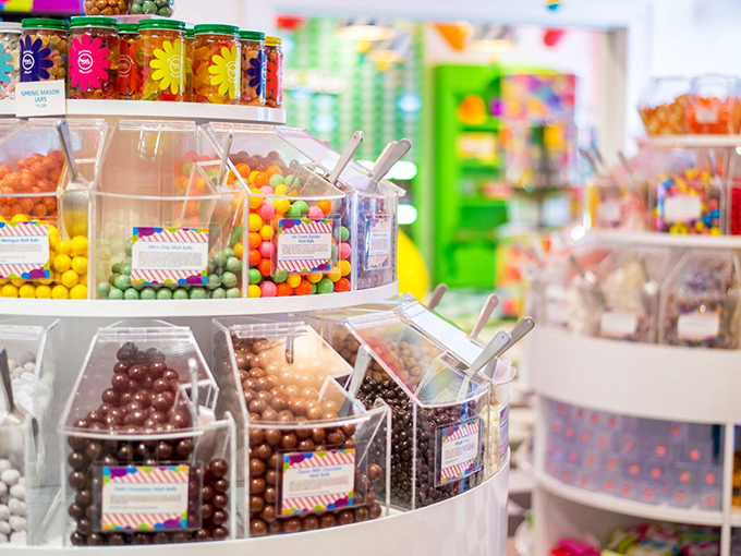 Decisions, decisions! Sweet Pete's candy dispensers stand like colorful soldiers, ready to march straight into your shopping bag.