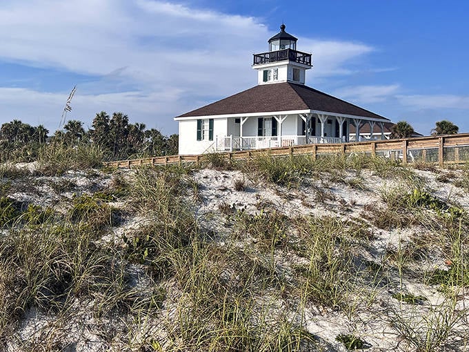 The Gasparilla Island Lighthouse stands sentinel over the landscape, its white facade gleaming like a pearl against the coastal backdrop.