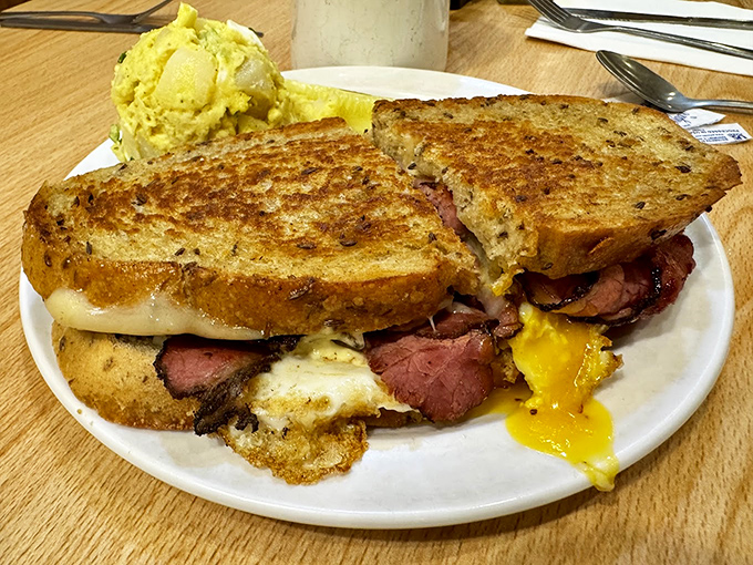 A classic deli sandwich that requires both hands and a strategy &ndash; piled high with meat and served with that signature pickle that means business.