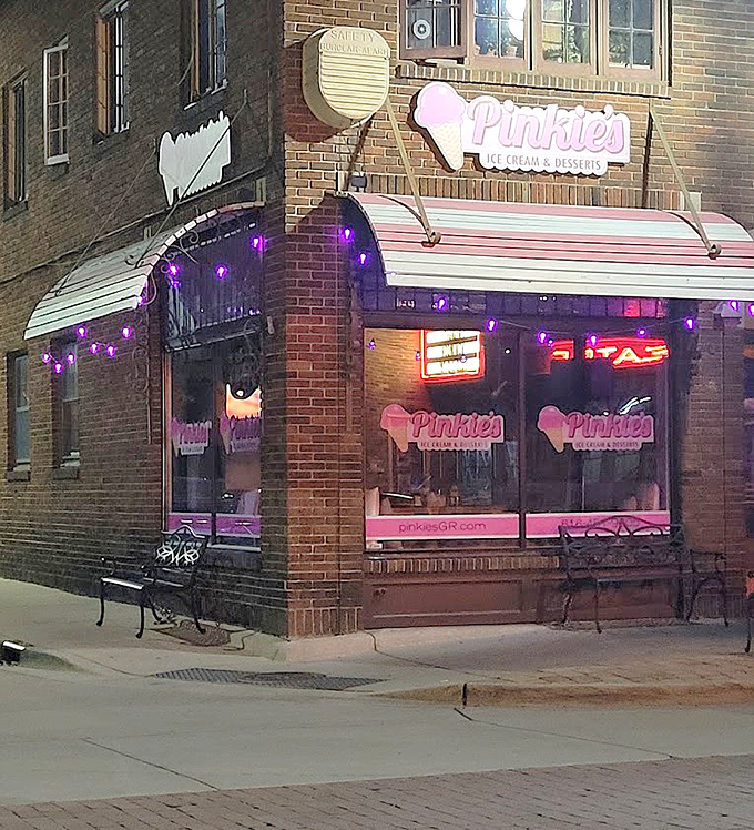 Pinkie's Ice Cream and Desserts glows with warm pink light, creating an inviting corner spot that's impossible to miss in Grand Rapids.