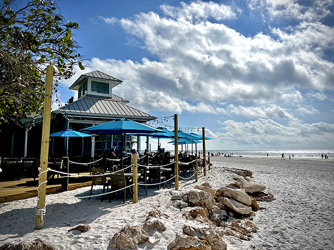 Oceanfront charm! The Sandbar's weathered wooden porch wraps around the building, offering diners front-row seats to Anna Maria's famous sunsets.