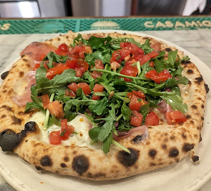 This Neapolitan-style masterpiece features the perfect char marks from Il Ritrovo's wood-fired oven, topped with fresh ingredients that transport you straight to Italy.